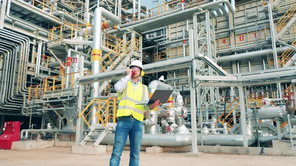 Oil Refinery Specialist is Using Gadgets for Communication at Work ...