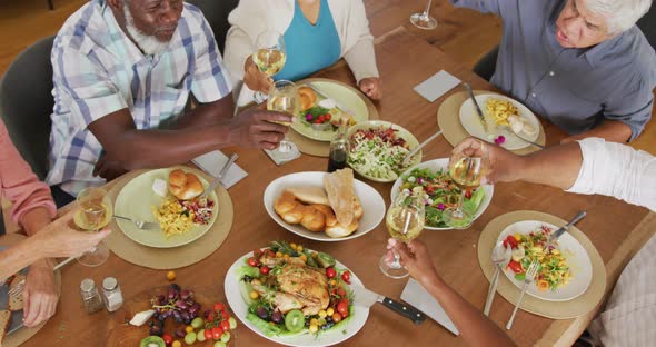 Happy senior diverse people having dinner at retirement home, Stock Footage