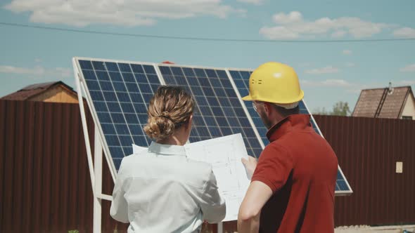 Supervisor and Engineer Discussing Solar Panels, Stock Footage | VideoHive