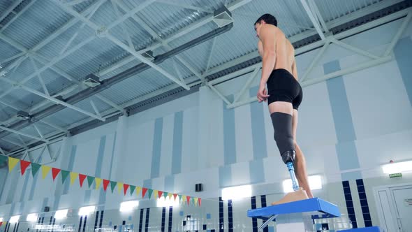 A Male with a Prosthetic Leg Is Preparing To Swim in a Pool, Stock Footage