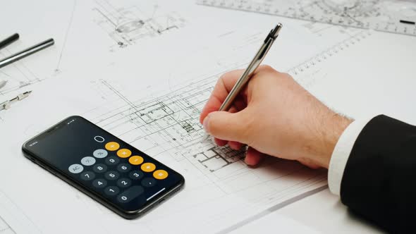 Architect Designer Counting on a Calculator Drawing Plan Blueprint ...