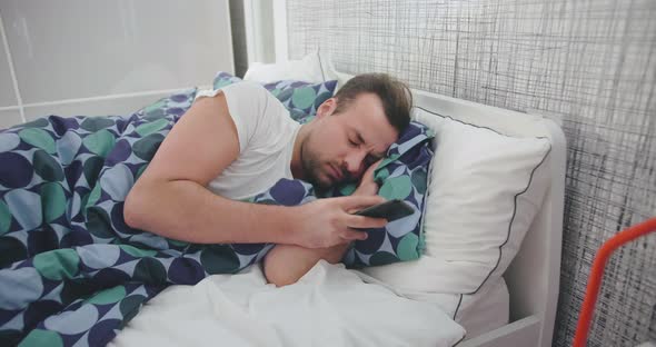 Sleeping Man Waking Up From Ringing Phone Late at Night, Stock Footage