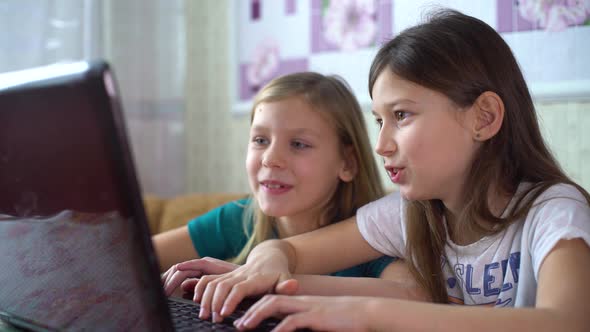 Internet Addiction By Little Girls Playing Online Games on Laptop ...
