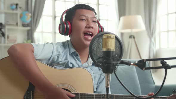 Boy Vlogger With Guitar Talking To Camera While Streaming. The Child Is ...