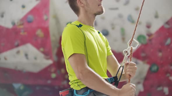 Man Belaying Another Climber on an Indoor Climbing Wall, Stock Footage