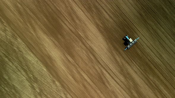 Spring agricultural land. Tractor with a cultivator on a spring field ...