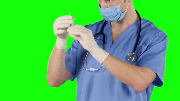 Doctor Preparing a Syringe for Injection. Green Screen. Closeup, Stock ...