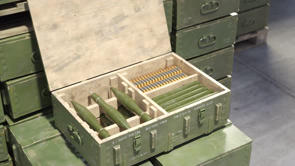 Closeup view at a military box with rifle ammo and RPG missiles in ...