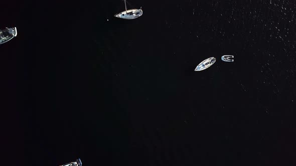 Dolly in overhead view of luxury boats and yachts on the shore of ...