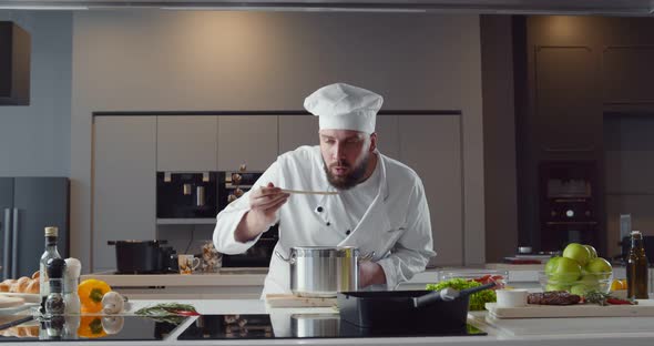 Professional Chef Tasting Sauce and Showing Sign for Delicious, Stock ...