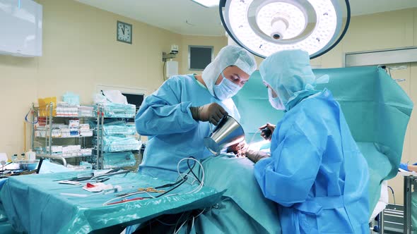 Surgeons are Pouring Liquid Into Incision During Operation, Stock Footage