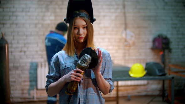 Young Sexy Woman Standing in the Industrial Grinding Workshop Holding ...