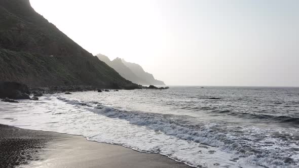 Rocky Volcanic Beach Surrounded By High Mountains and Cliffs Aerial ...