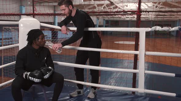 AfroAmerican Boxer Sitting in Ring Corner Between Match Rounds Drinking ...
