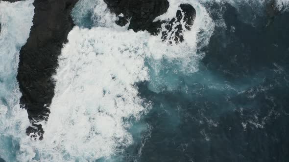 Aerial view of the crispy waves breaking on the rocks., Stock Footage