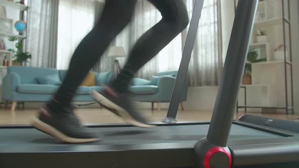 Side View Legs Of Asian Woman Running On A Treadmill At Home, Stock Footage