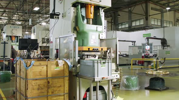 A large industrial punch press forming high precision metal parts for ...