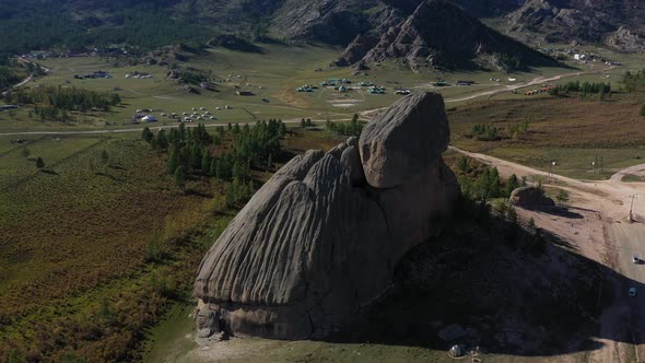 Aerial circling view of Gorkhi-Terelj's sacred rock in Mongolia, also ...