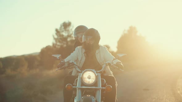 Couple Riding Cruiser Motorcycle In The Road With Bright Sunset ...