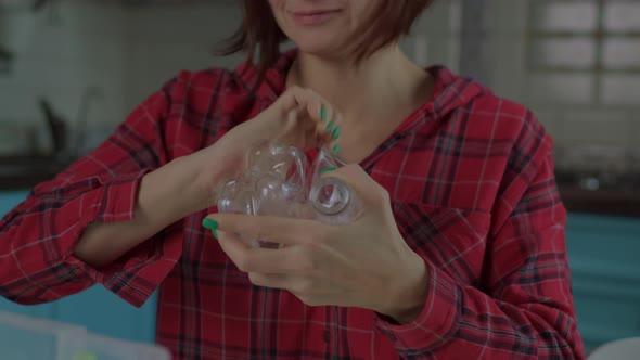Female Compressing Plastic Bottle While Sorting Recyclable Waste at ...