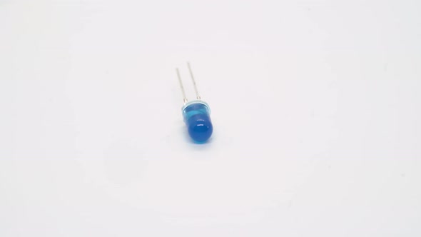 Blue LED Electronic Component Rotates on White Background Isolated ...