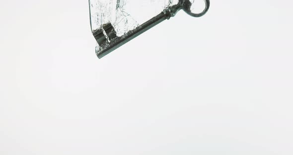 Key falling into Water agaisnt White Background, Slow Motion 4K, Stock ...