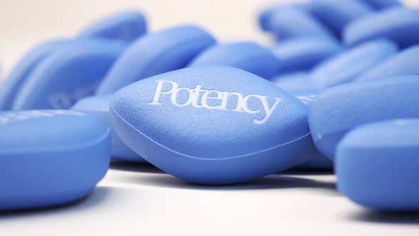 Pile of blue pills on a bright background. Dolly zoom camera movement ...