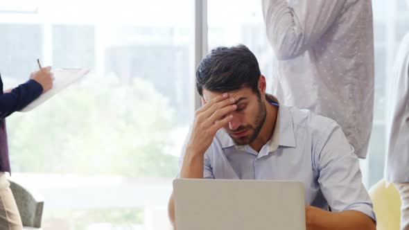 Tensed male business executive using laptop, Stock Footage | VideoHive