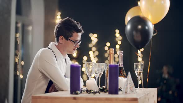 Portrait of Upset and Sad Man Sitting Alone at Table After Party on ...