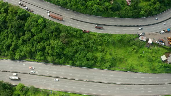 Flyby sideways over two parallel expressway roads as the traffic zooms ...