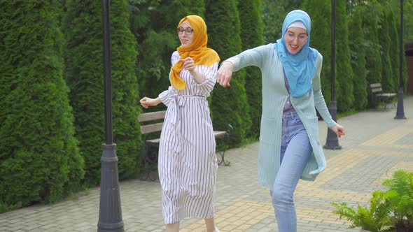 Two Positive Muslim Young Women Dancing in the Park, Stock Footage
