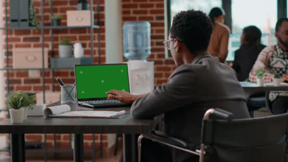Man with Disability Looking at Greenscreen on Computer, Stock Footage