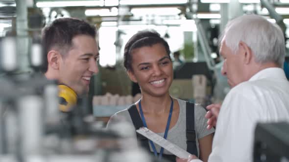 Cheerful Factory Workers Discussing Tasks, Stock Footage | VideoHive
