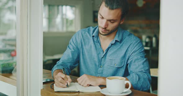 Man Writing in Coffee Shop, Stock Footage | VideoHive