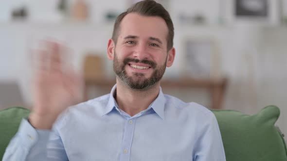 Welcoming Young Man Waving at Camera, Stock Footage | VideoHive