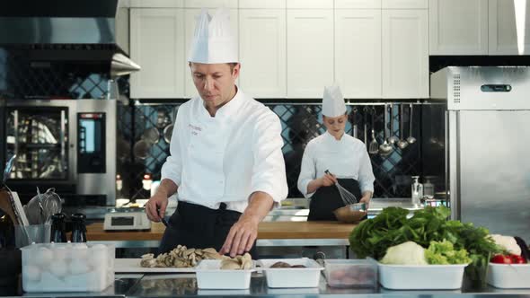 Restaurant Kitchen: Portrait of Male and Female Chefs Preparing Dish ...