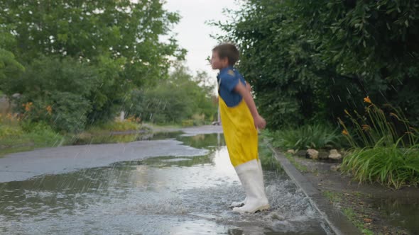 Children Holiday, Cheerful Kid in Rubber Boots and Overalls Have Fun ...