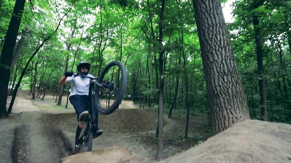 A Man Is Doing Stunt Jumping on His Bmx in the Forest, Stock Footage