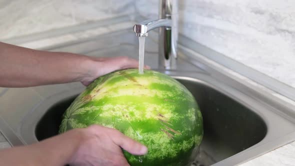 Man Wash the Watermelon in the Sink on Kitchen, Stock Footage | VideoHive