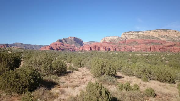 Aerial view rising above juniper bushes to see desert landscape, Stock ...