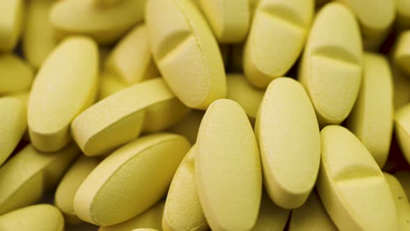 Bright Yellow Antibiotics and Antiviral Pills Lie Together and Rotate ...