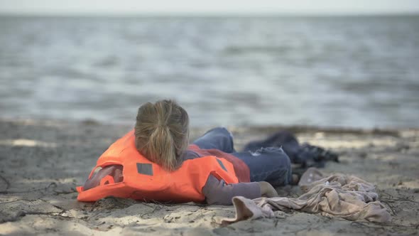 Little Girl Wearing Life Jacket Lying on Shore, Survived Plane Crash ...