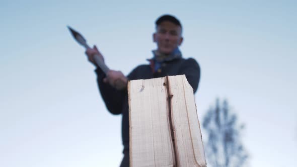 Low angle shot man splits log with splitting hatchet, Stock Footage