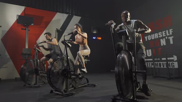 Group of multi ethnic people riding spinning bike or bicycle, Muscle ...