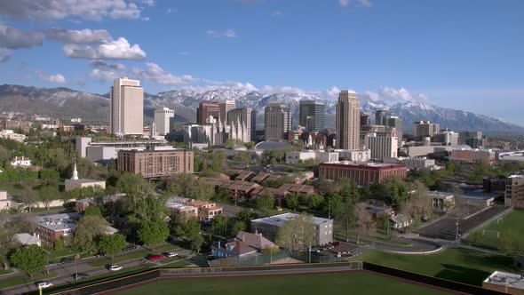 Rising aerial view of Salt Lake City against the Wasatch Mountains ...