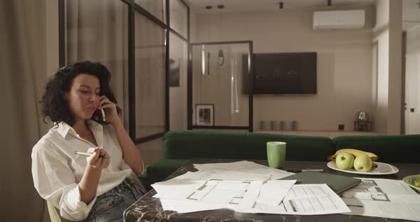 Woman Discussing Architectural Drafts During Phone Call, Stock Footage
