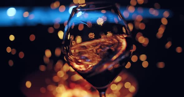 Closeup of Female Hand Waving Wine in a Glass on Defocused Cozy Camp ...